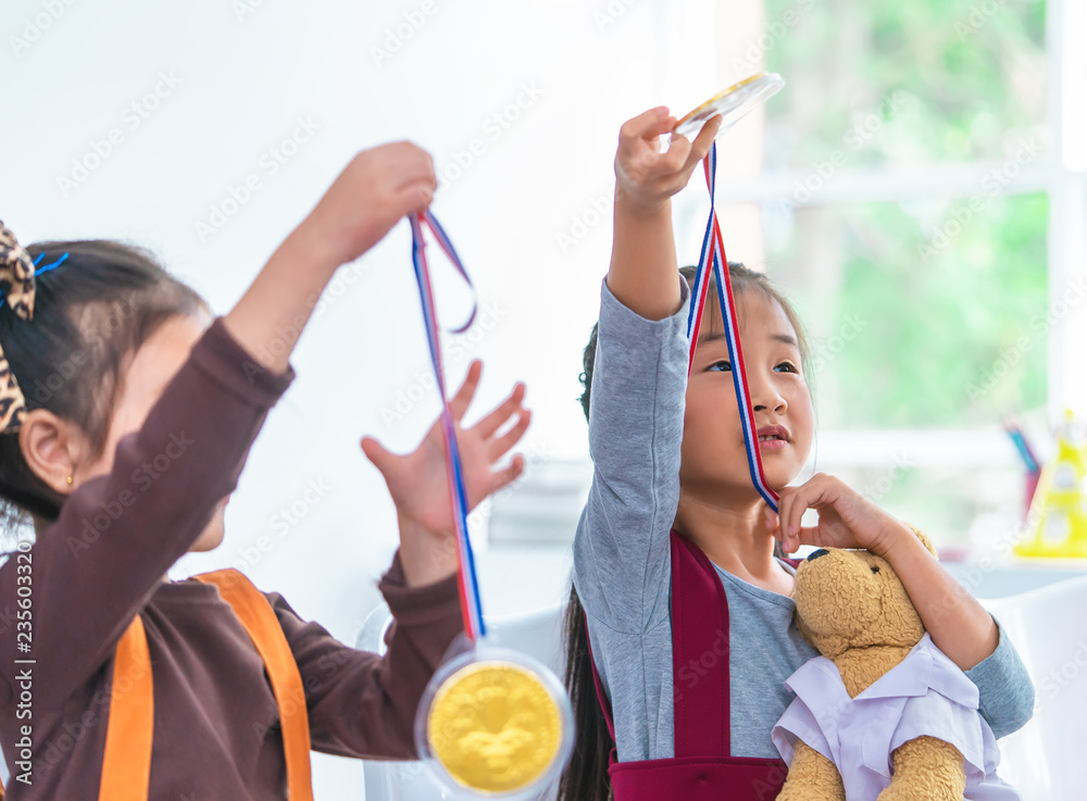 Little girl is holding gold medal for student award. Stock Photo ...