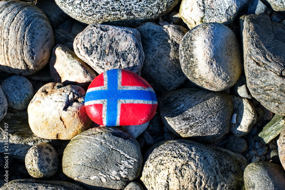 Image of the flag of Norway on a stone, between sea pebbles and ...
