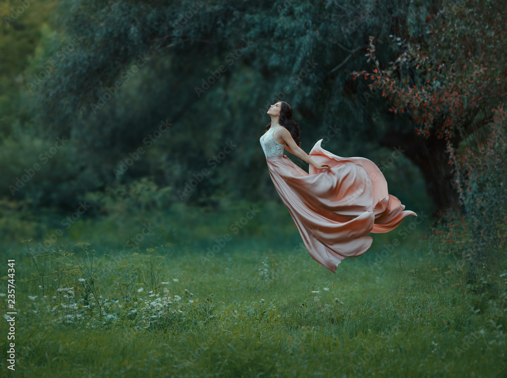 Young Slim Woman With Dark Hair And Neat Hair Dressed Long Luxurious Waving Flying Dress Up Into