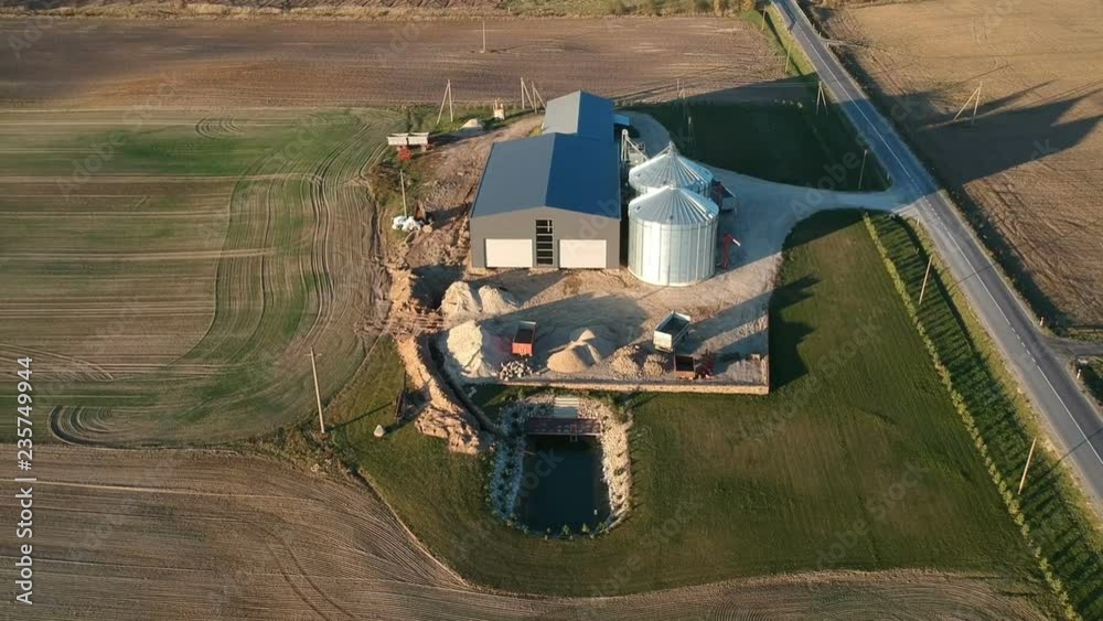 Grain dryer building on field and rural asphalt road, aerial view Stock ...