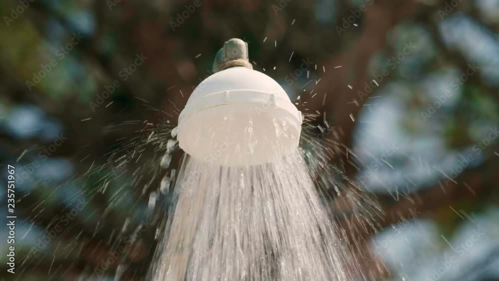 Close-up of outdoor shower on beach with falling pure splash water low ...