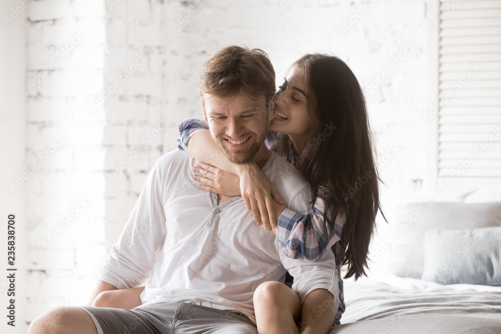 Young happy couple in love having fun together in bedroom at home ...
