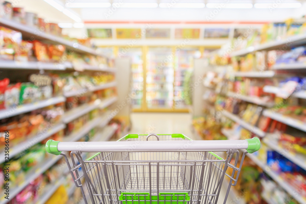 Shopping cart with Supermarket convenience store aisle shelves interior ...