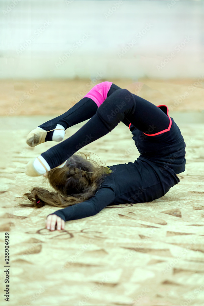 training in children's rhythmic gymnastics group , girl doing a ...