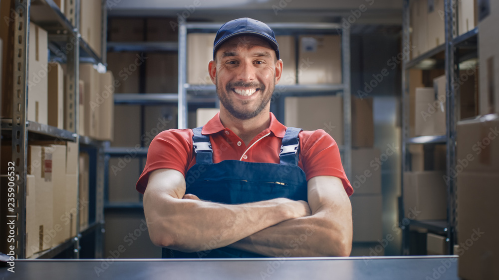 Warehouse Worker Wearing Uniform Crosses Arms and Smiles. Stock Photo ...