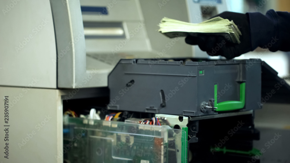 Security man opening ATM safe, taking out bundle of dollars, cash-in ...