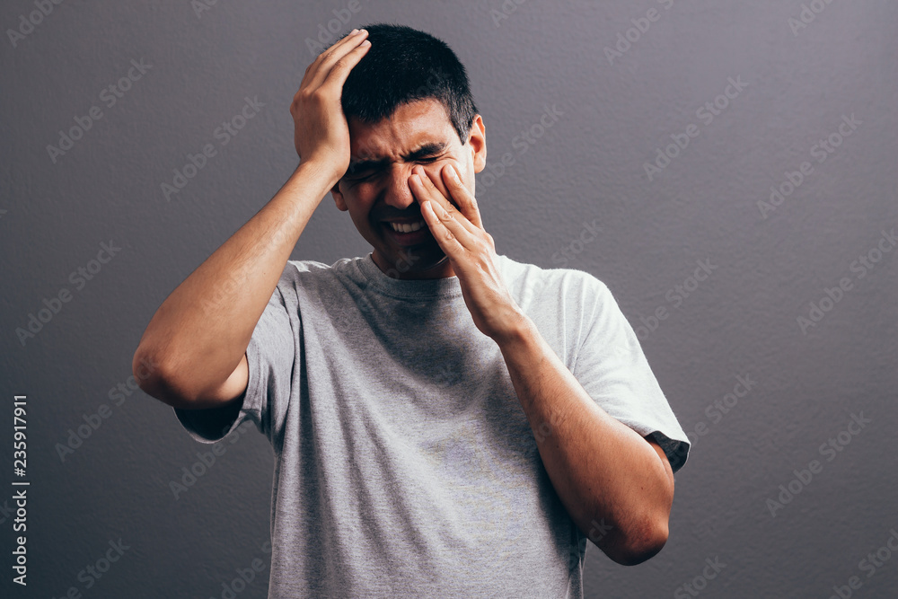 Sad man holding his nose because sinus pain Stock Photo | Adobe Stock
