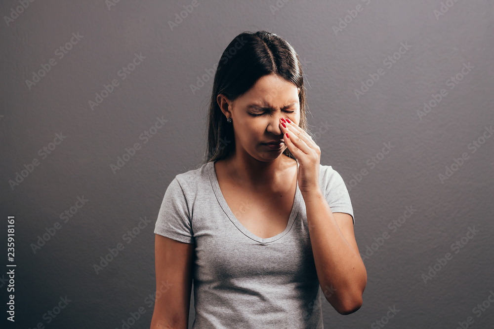 Sinus pain, sinus pressure, sinusitis. Sad woman holding her nose and ...