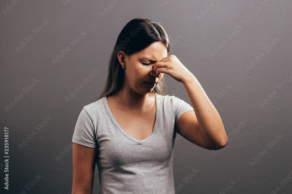 Sinus pain, sinus pressure, sinusitis. Sad woman holding her nose and ...
