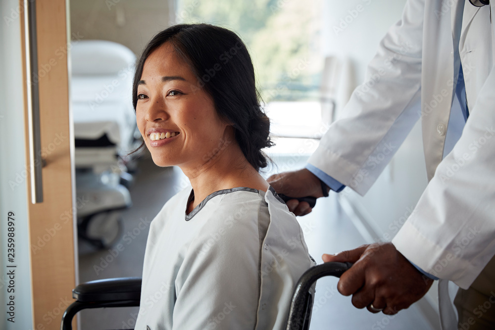 Doctor pushing woman in wheelchair Stock Photo | Adobe Stock