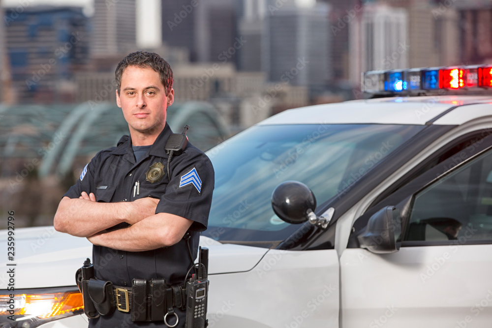 Police sergeant leaning agains car Stock Photo | Adobe Stock