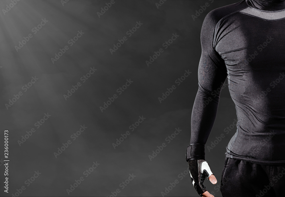Half of a man dressed in a black sports sweatshirt. Muscled, athletic ...