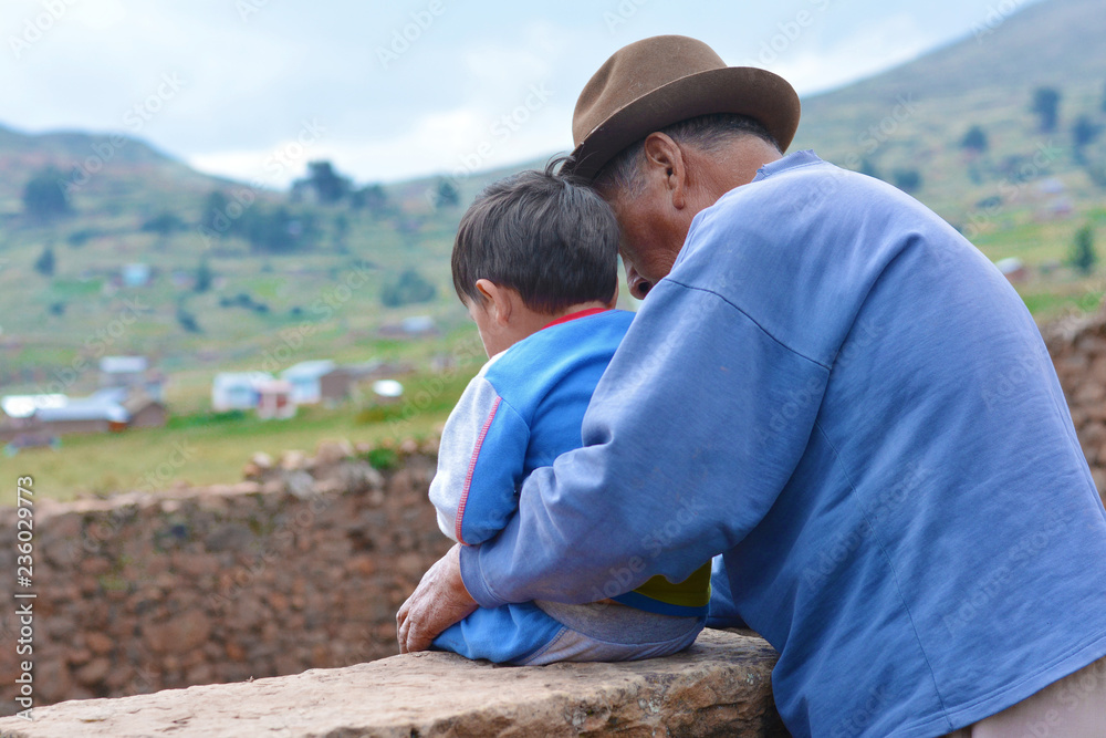 Native american grandfather hugging his grandchild outside. Stock Photo ...