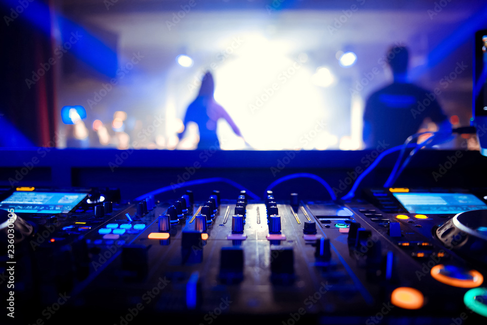 DJ turntable console mixer controlling with two hand in concert ...