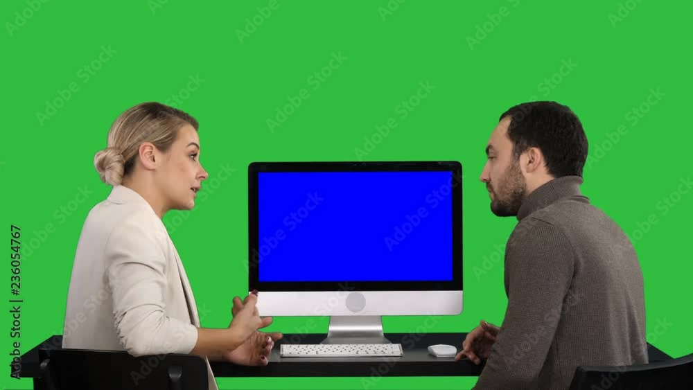 Business people having meeting around monitor of computer talking about ...