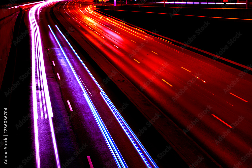 Cars light trails on a curved highway at night. Night traffic trails ...