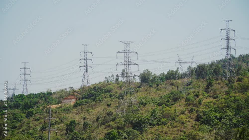 Power pylons and high voltage lines passing through mountain cordillera ...