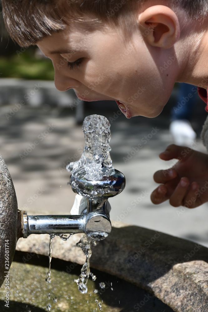 the child drinks water from the fountain, boy, girl, child, portrait ...