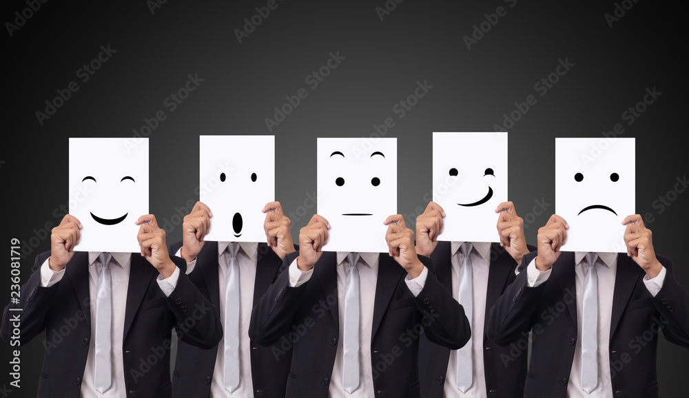 five businessman holding a card with drawing facial expressions ...