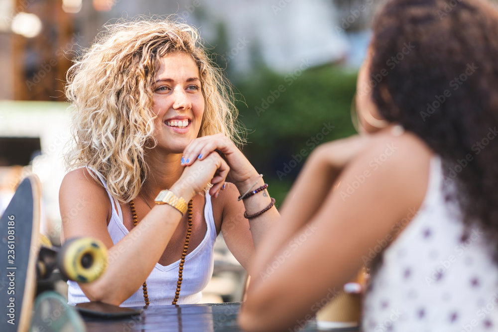 Two happy friends talking together at table outdoors Stock Photo ...