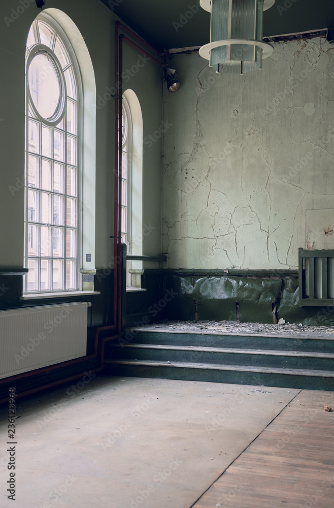 Gloomy green derelict stairwell sits unfound for decades. Built up dust ...