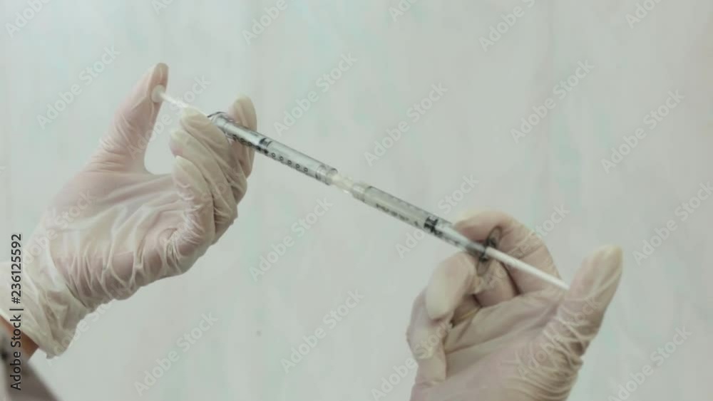 Mix the medicine. The doctor with a syringe mix different types of ...