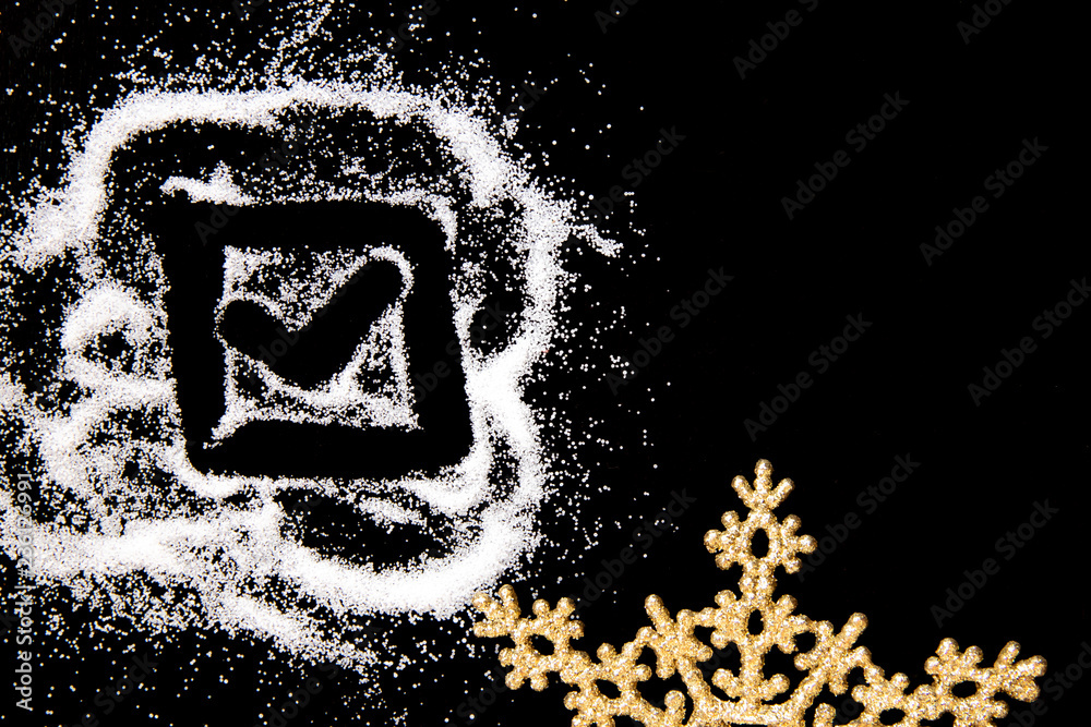 Checking mark symbol in checkbox drawing by finger on white salt powder ...