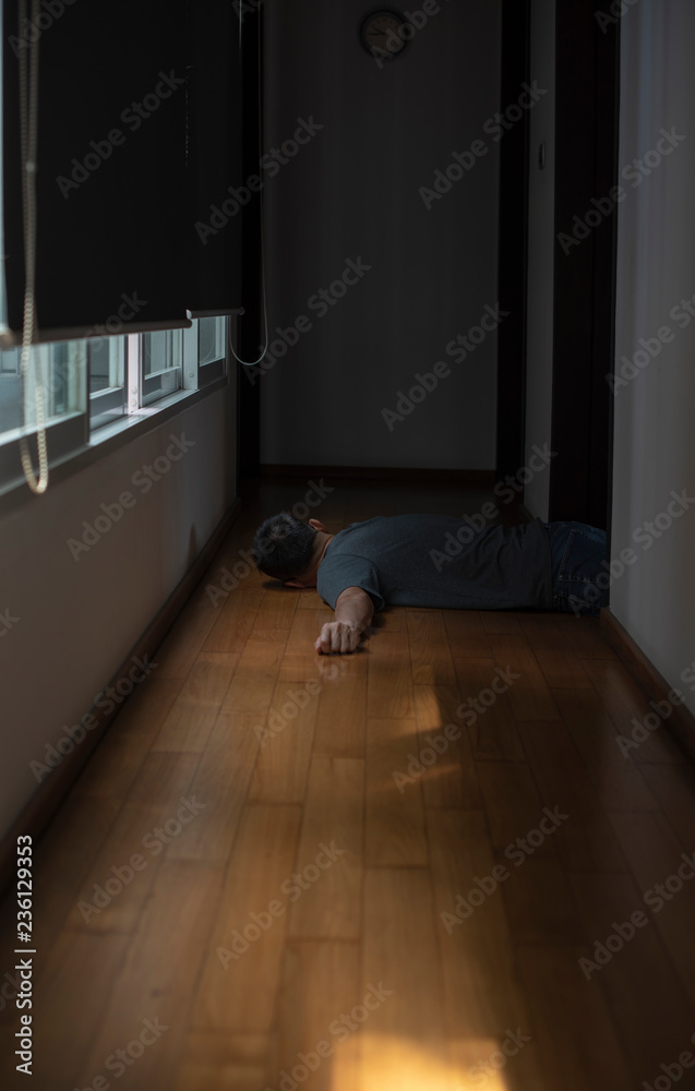 An old man lying down unconscious from a sudden heart attack in front ...