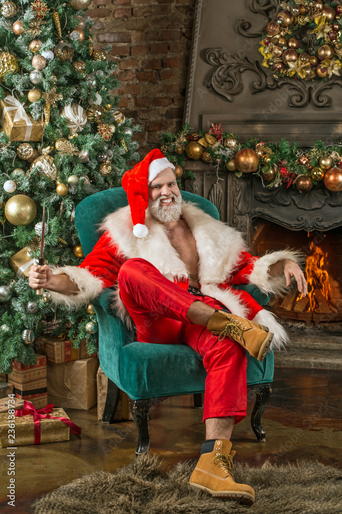 Angry Bad Santa Claus, is in the Christmas room with a fireplace and a ...