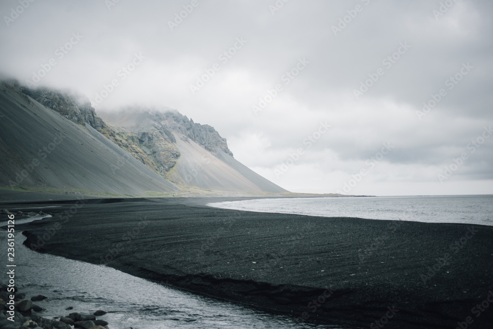 Epic and impressive landscape of cold and grey volcanic beach with ...