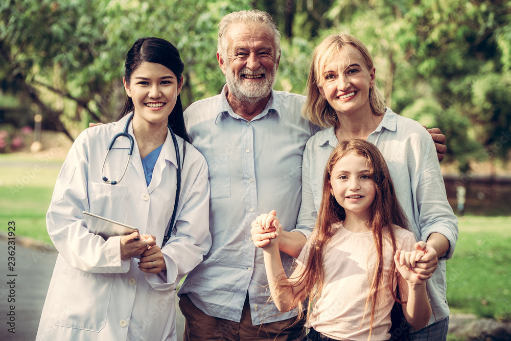 Happy healthy family and doctor talking in the park. People healthcare ...