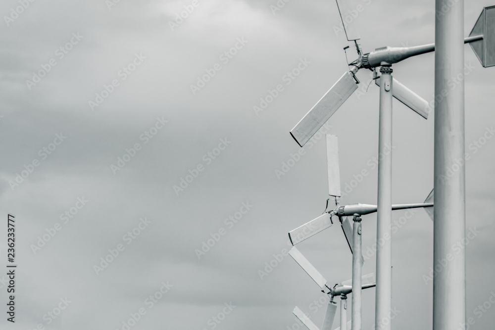 Horizontal axis wind turbine with grey sky and clouds. Wind energy in ...
