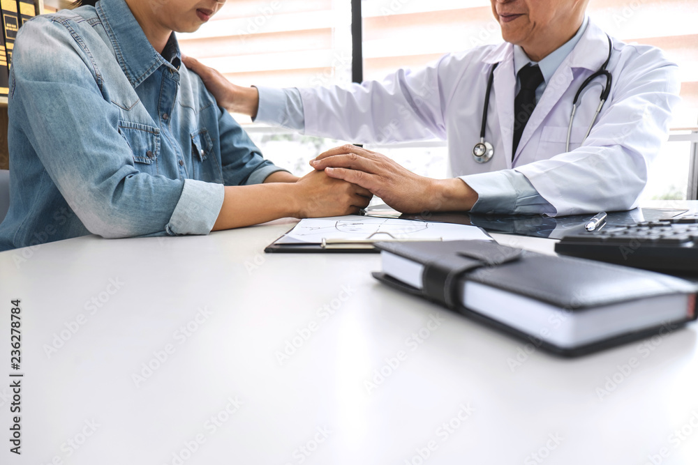 Doctor having support and comforting in conversation with patient and ...