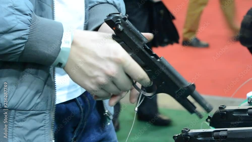Person holding a gun in hand close-up. Firearms gun submachine sniper ...
