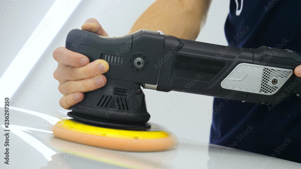 Closely shown as a professional worker polishes the transport (car ...