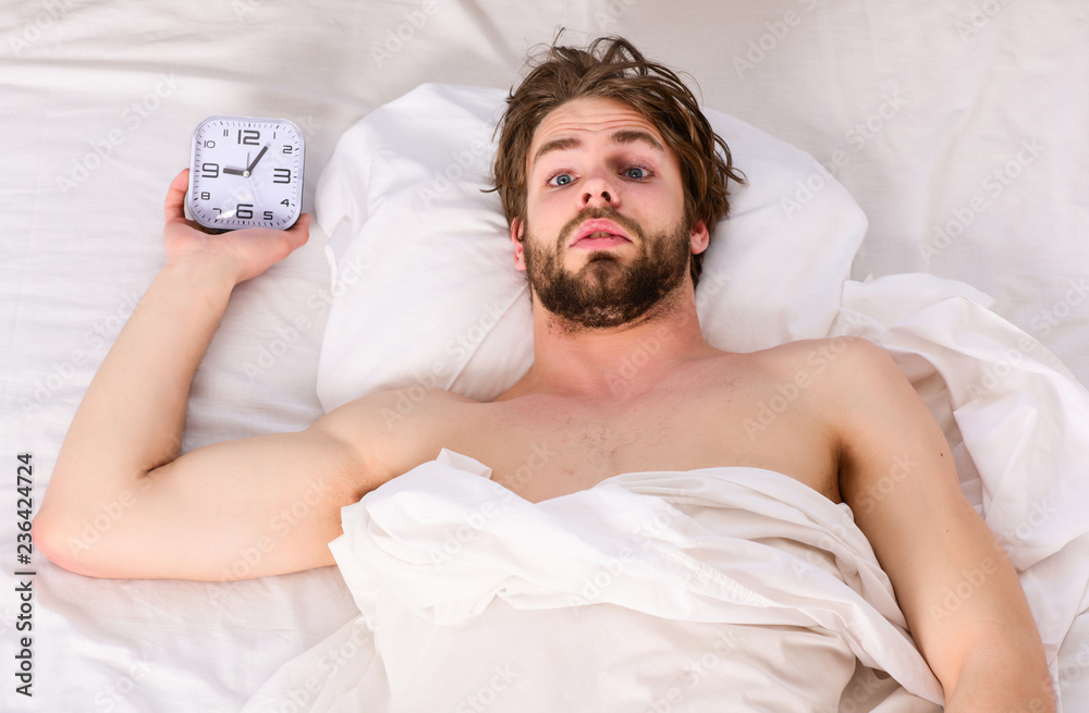 Handsome man yawning and stretching his arms up. Cheerful young man is ...