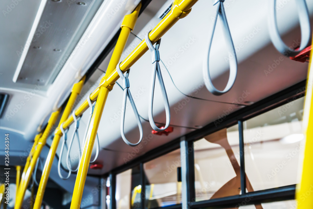 handrails in the cabin of a modern and comfortable city bus or electric ...