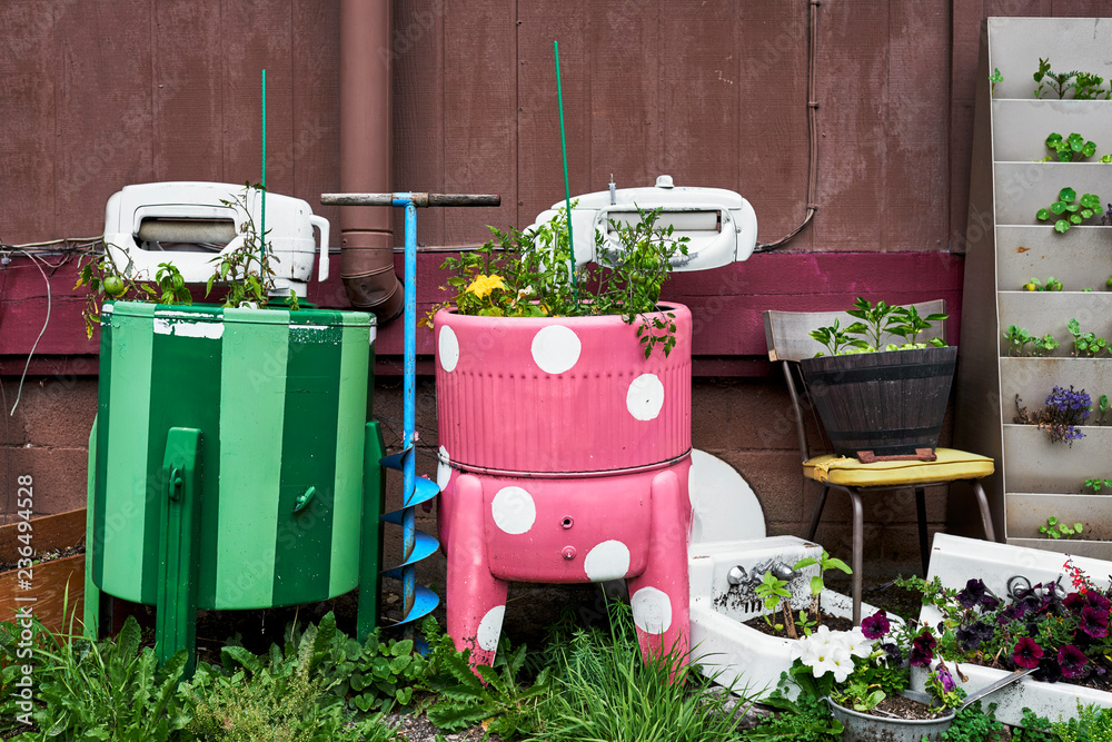 vintage washing machines used as planters for a garden Stock Photo ...