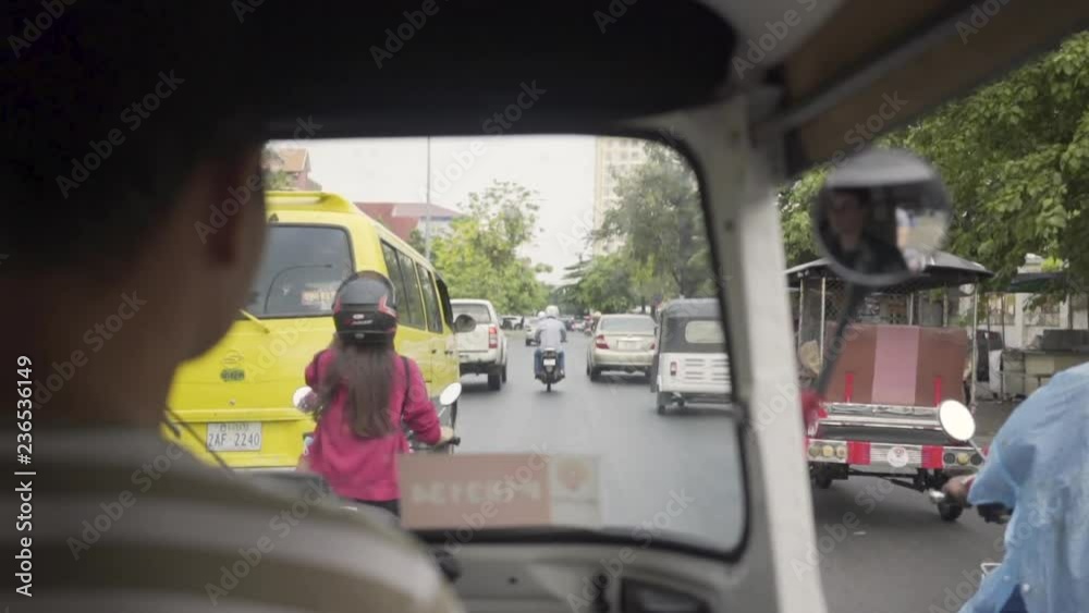 Riding in the back of a tuk-tuk in Southeast Asia on a rainy day ...