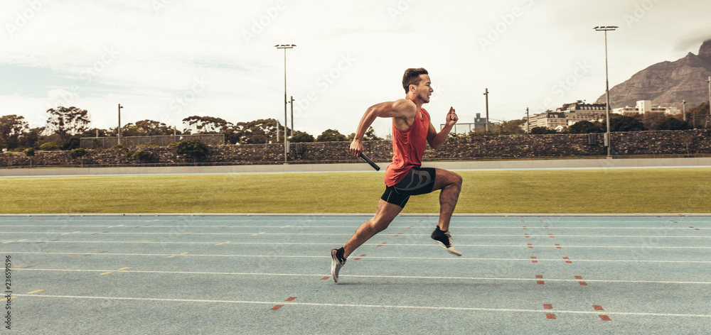 Sprinter running on track in a stadium Stock Photo | Adobe Stock