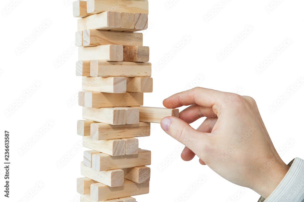 Man's hand taking or putting a block to an unstable and incomplete ...