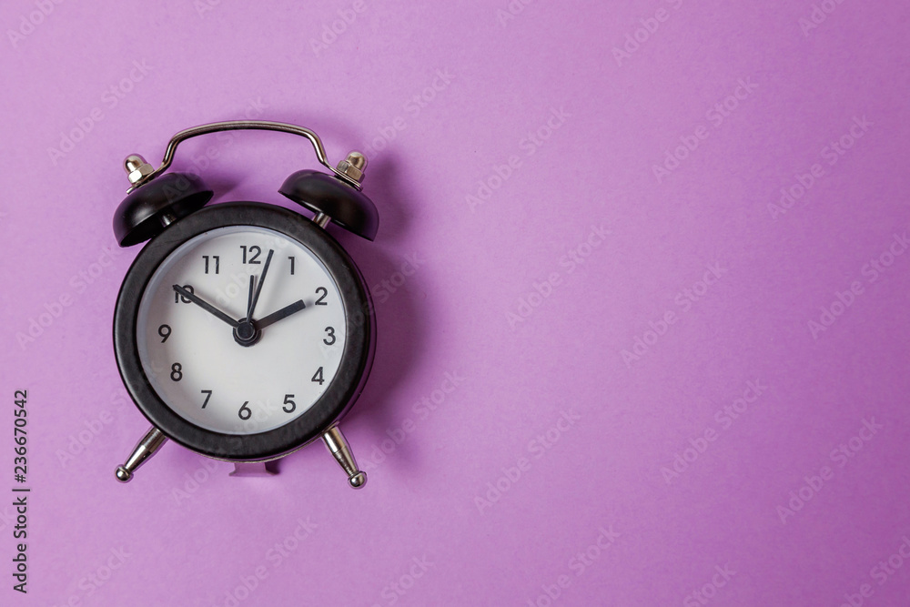 Ringing twin bell vintage classic alarm clock Isolated on purple violet ...