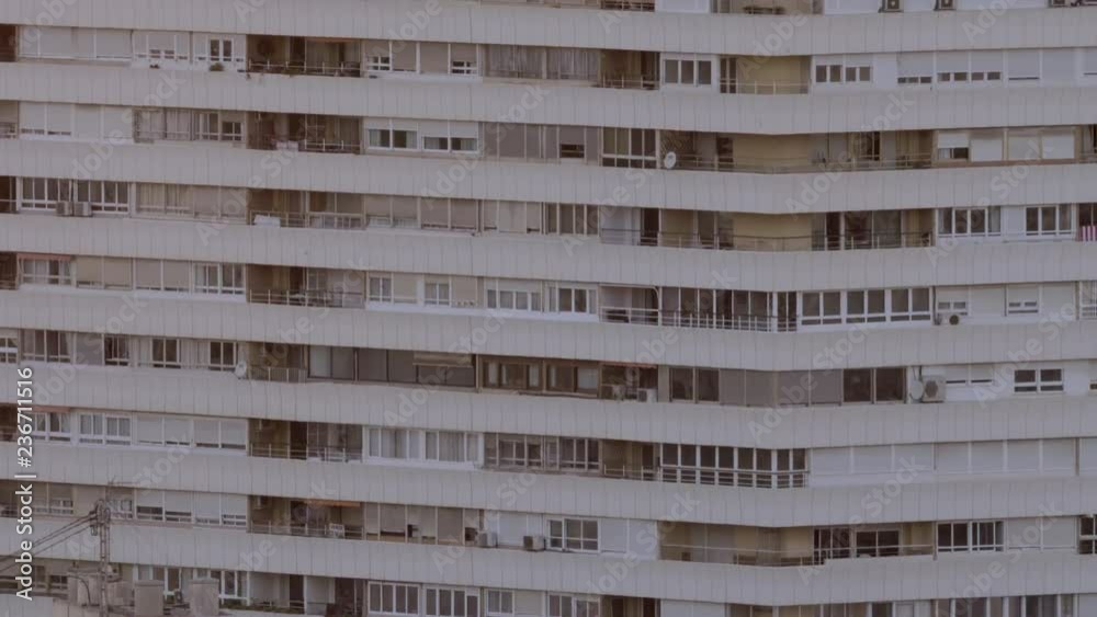 A huge multi storey facade of a white apartment building. Glazed and ...