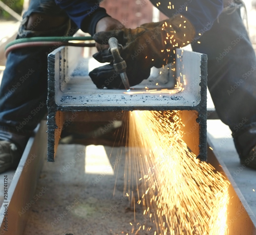 H - Beam is being cut by workers.To have the desired lenght. Stock ...