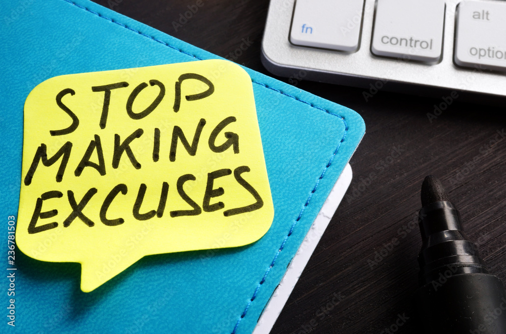 Stop making excuses written on a piece of paper. Stock Photo | Adobe Stock