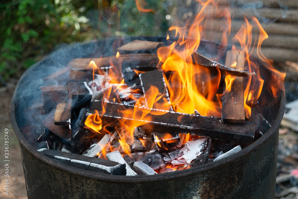 Fire and smoke in Barrels Oil Tank, Burning charred firewood in the ...