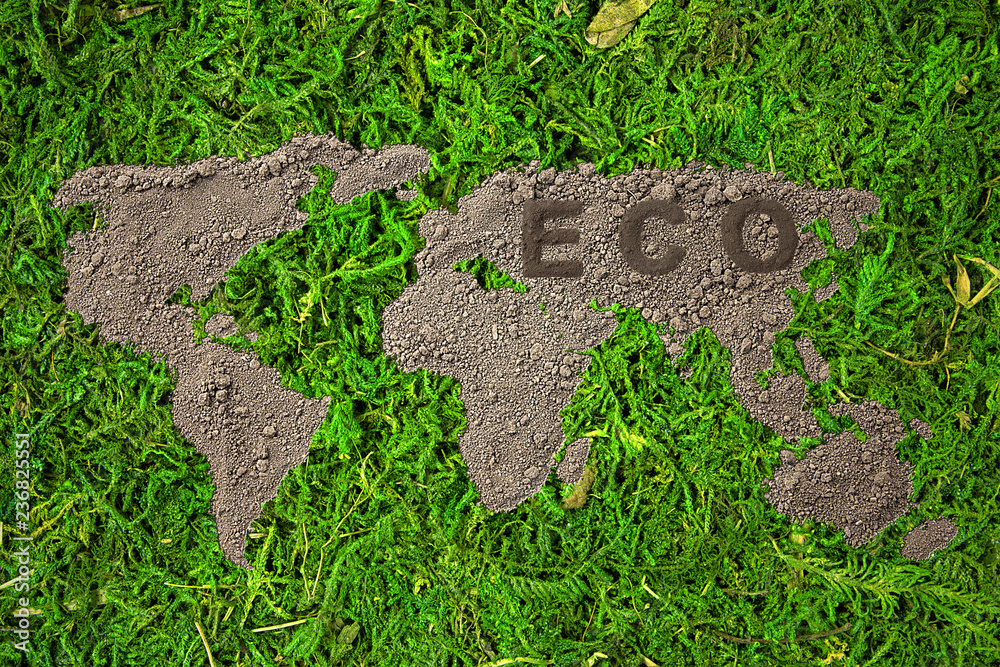 Concept ecology. World map, globe from the soil on natural green ...