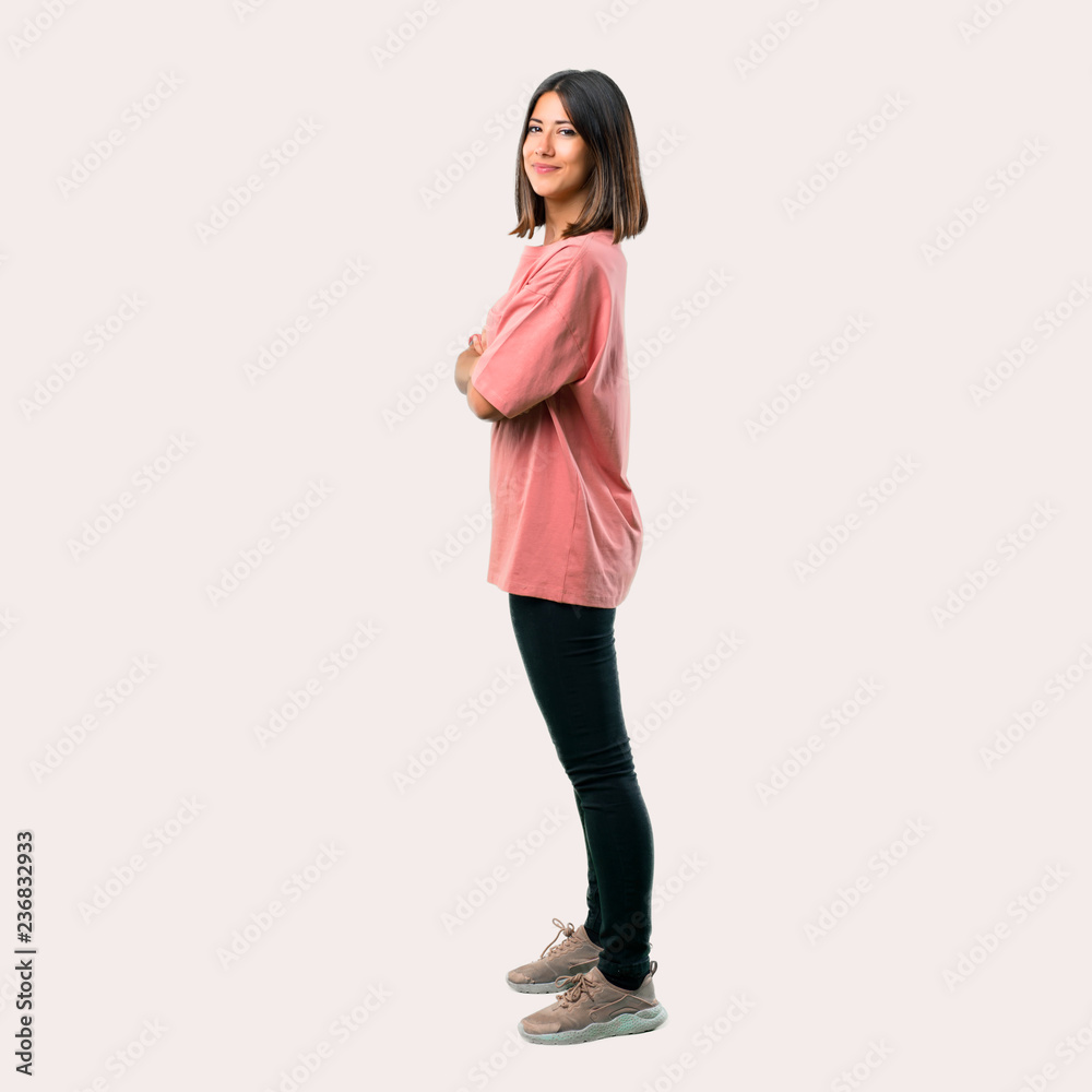 Full body of Young girl with pink shirt keeping the arms crossed in ...