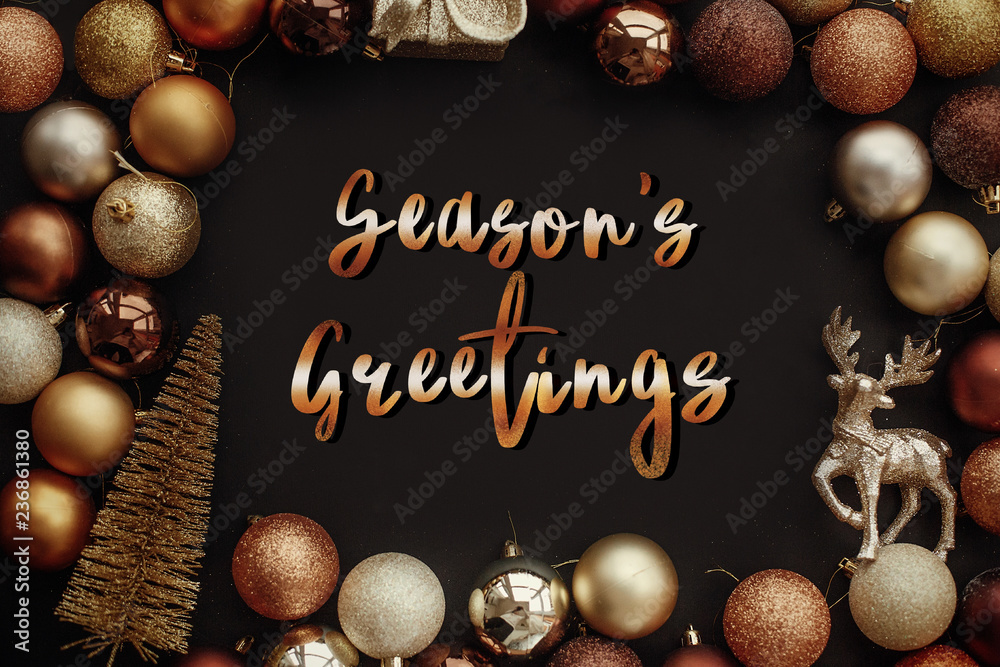 Season's greetings text, handwritten golden sign at christmas gold ...