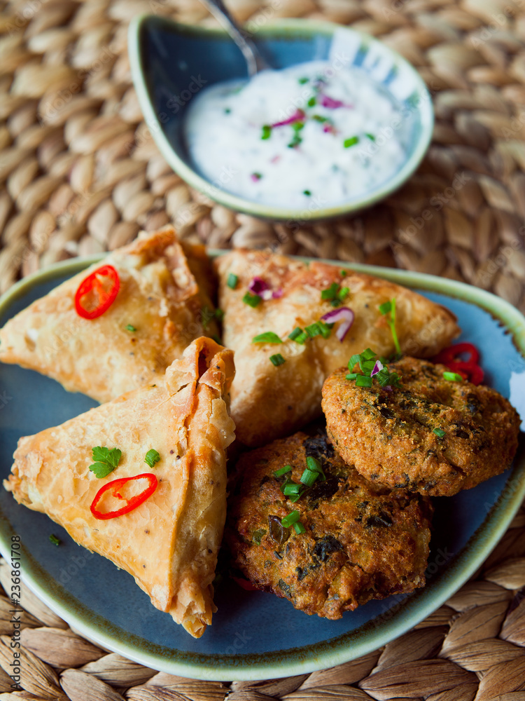 Indian Vegetable snacks - pakora, samosa, onion bhaji with coriander ...